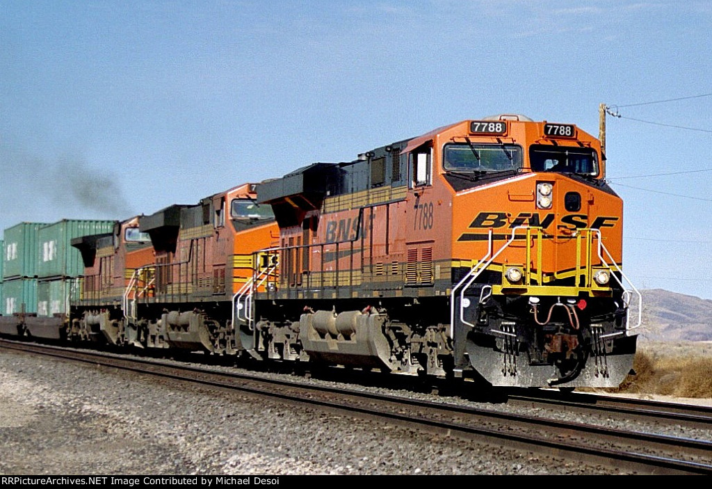 BNSF ES-44DC #7788 leads an eastbound stacker across Mesa Rd.